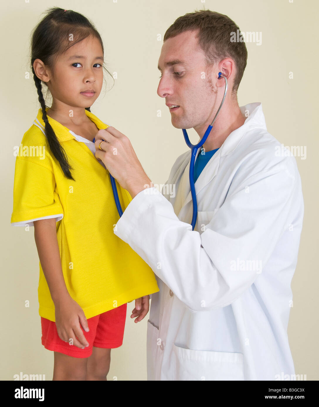 Male Doctor with Asian child patient getting check up Stock Photo - Alamy