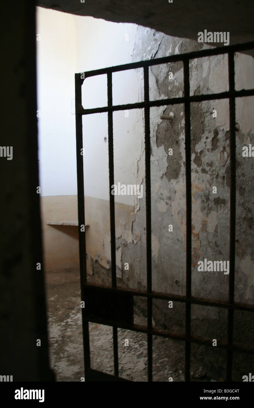 one old moody dark derelict empty prison cell Stock Photo - Alamy