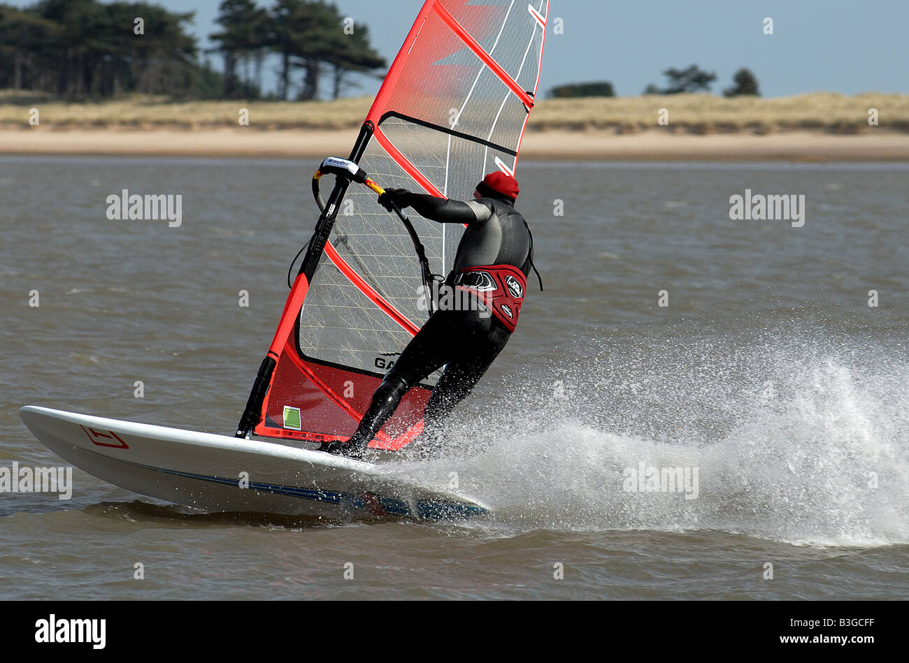 Paul Perry carve-gybing his windsurfer at Wells on the North Norfolk ...