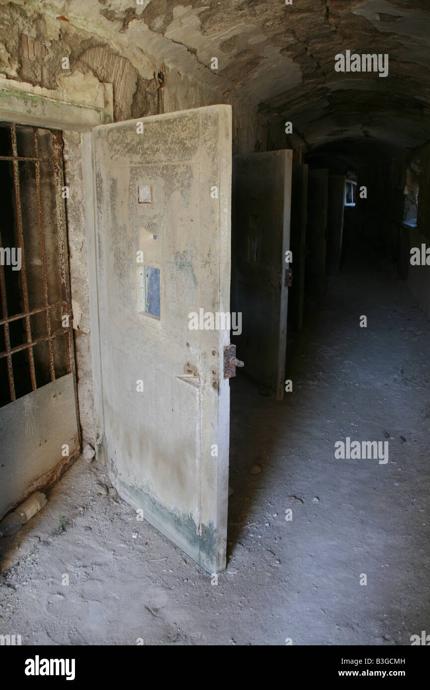 one old moody dark derelict empty prison cell Stock Photo - Alamy