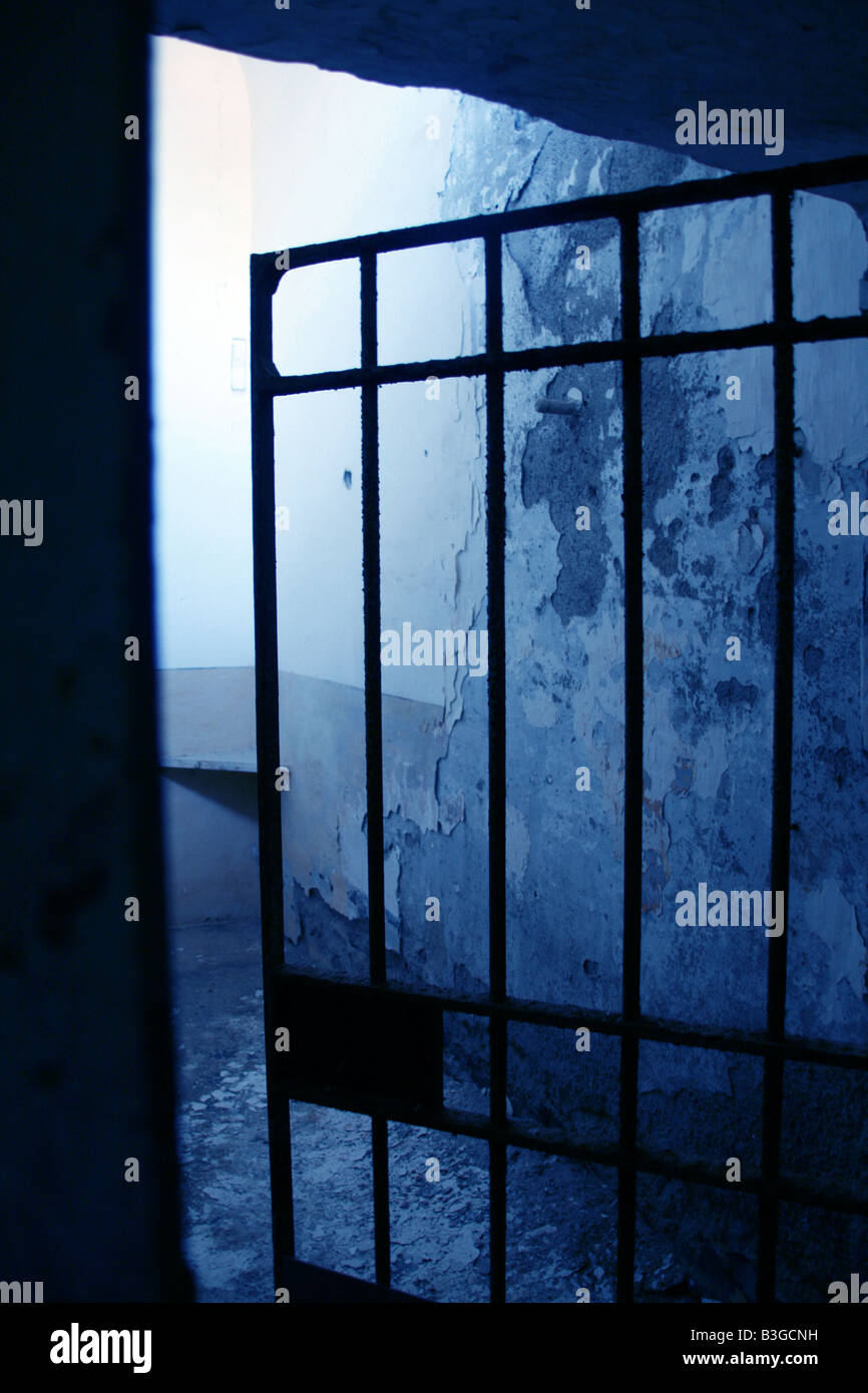 one old moody dark derelict empty prison cell Stock Photo - Alamy
