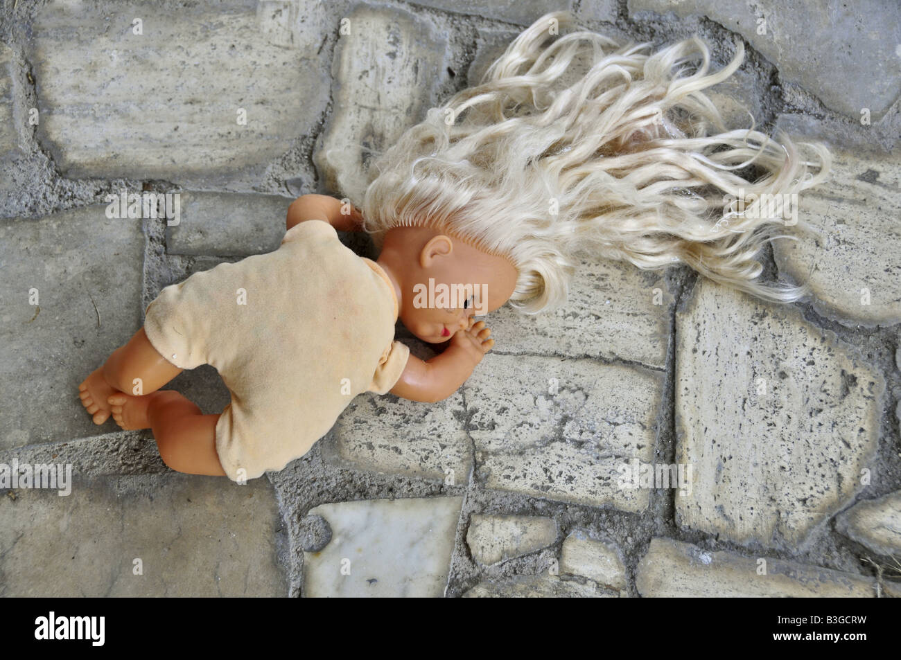 death concept with an old and long haired blonde doll Stock Photo - Alamy