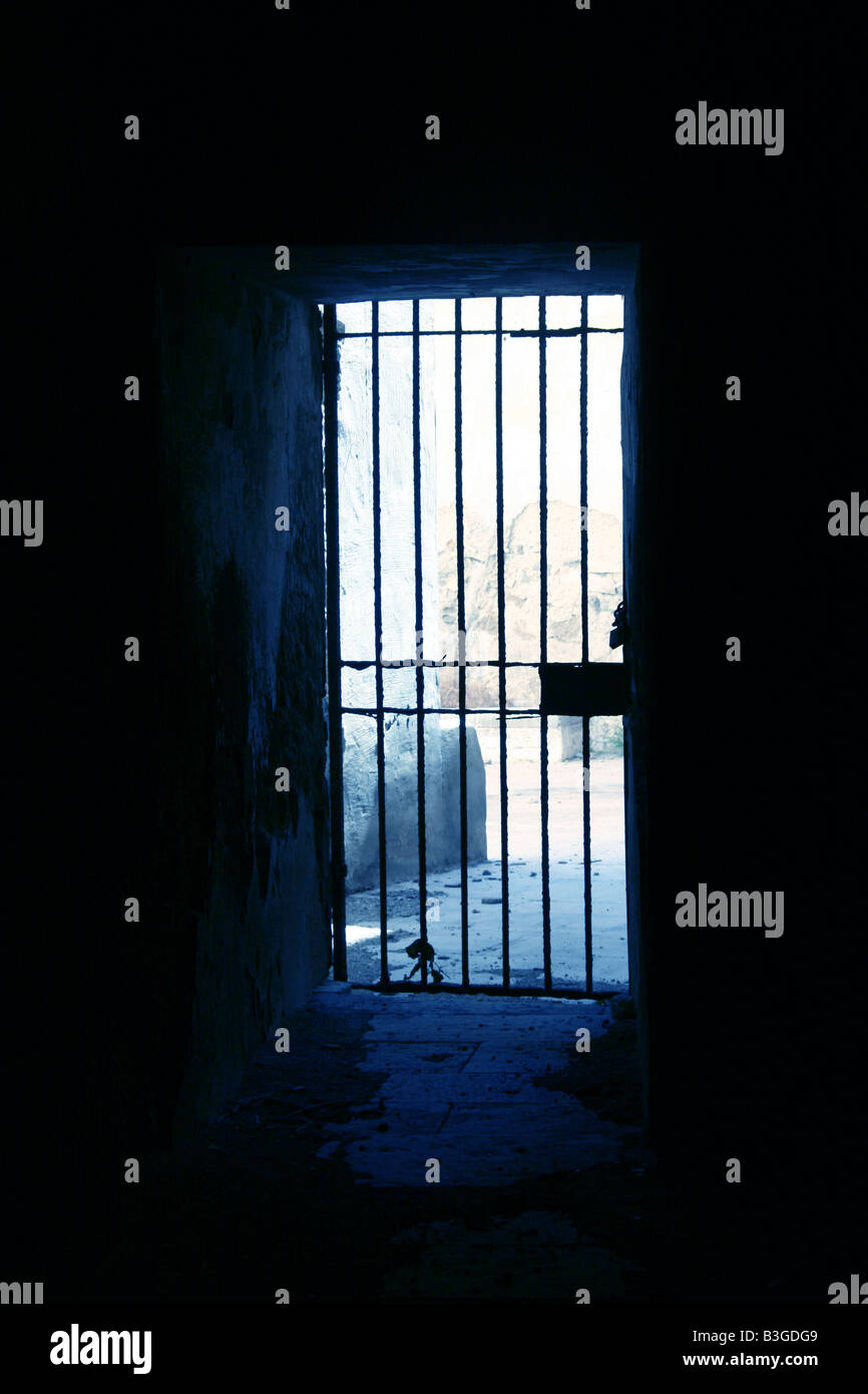 one secluded prison cell door in dark black room Stock Photo - Alamy
