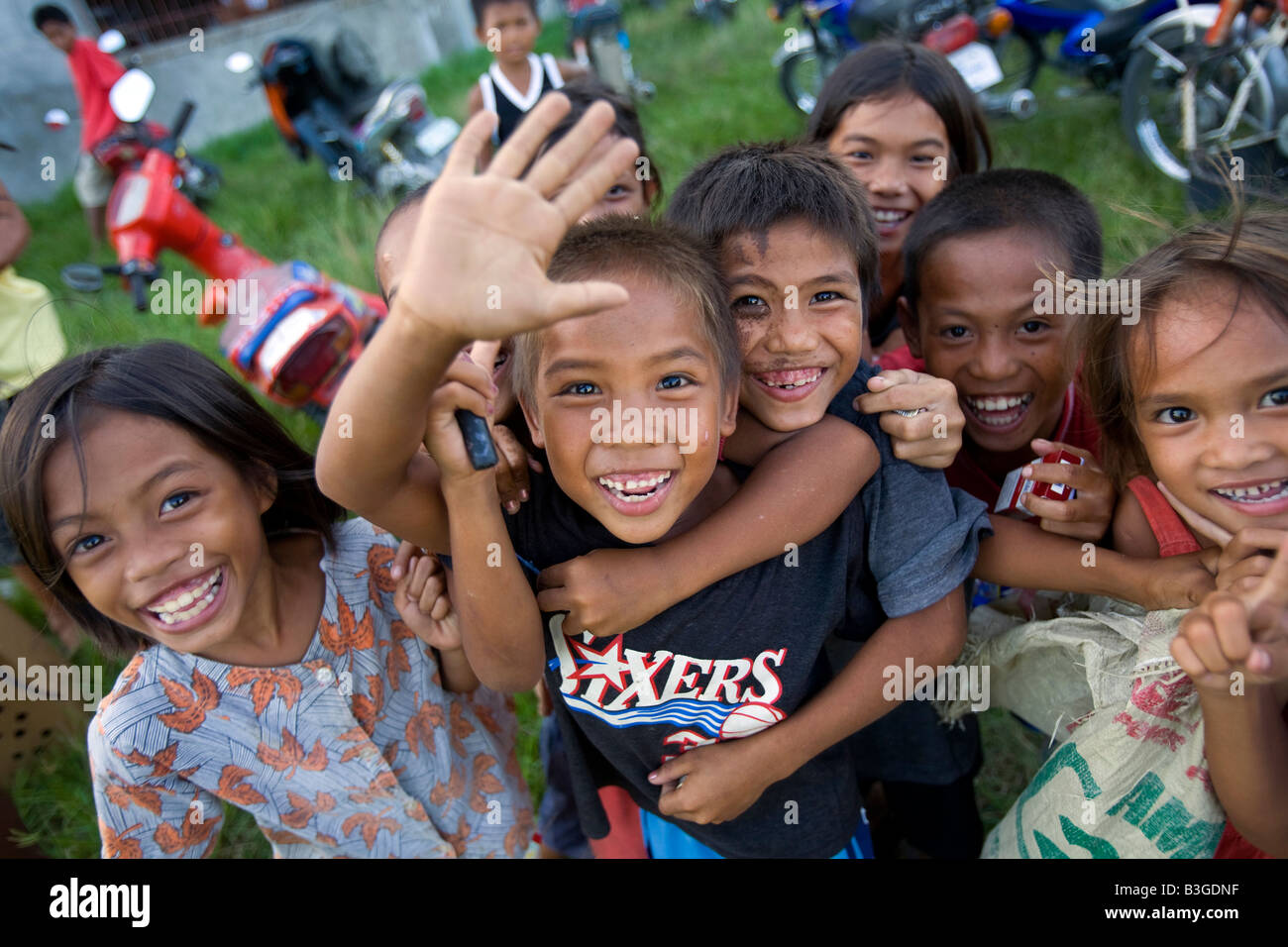 Filipino children play while waiting for their parents outside a ...