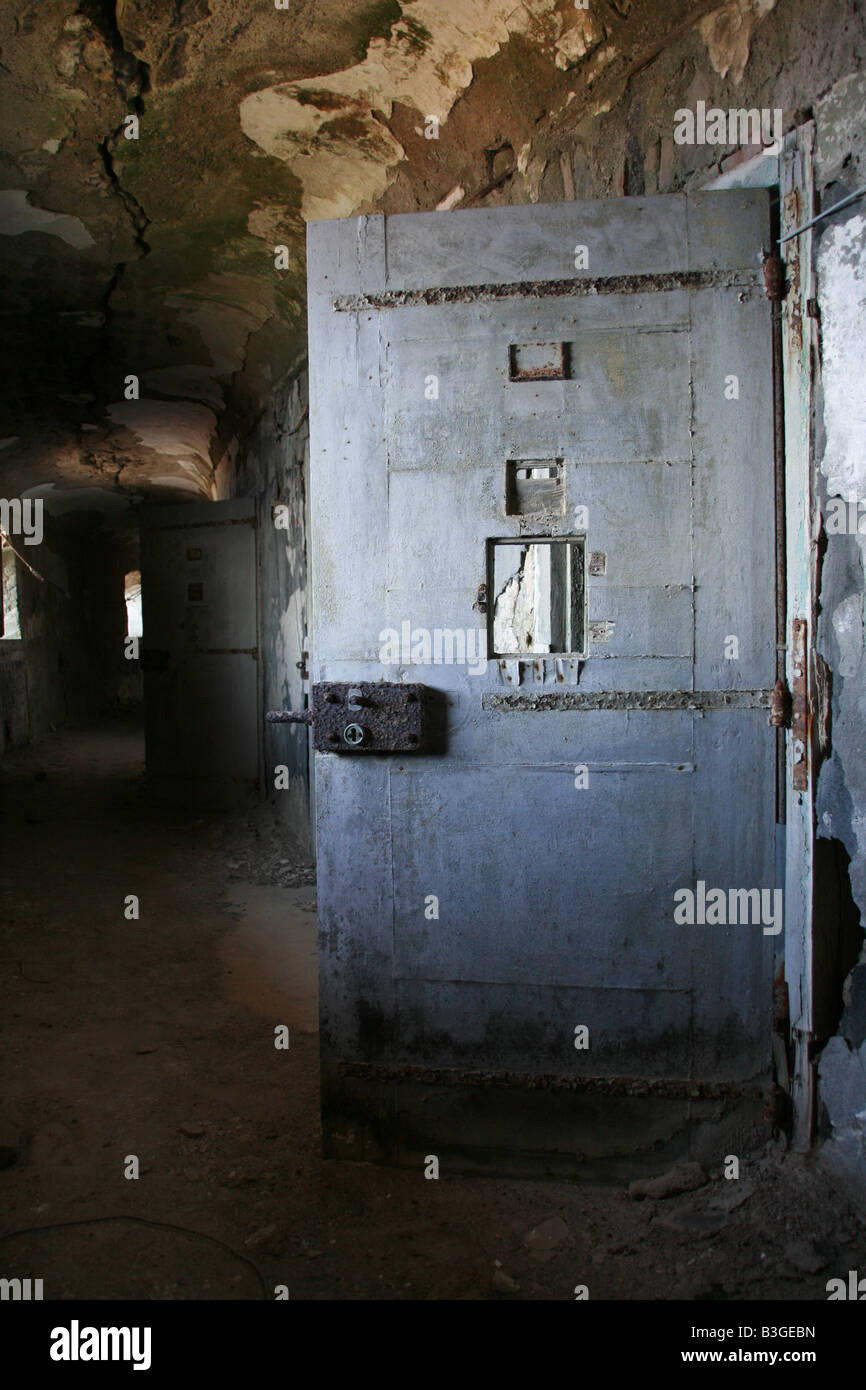 secluded prison cell doors in dark black corridor Stock Photo - Alamy