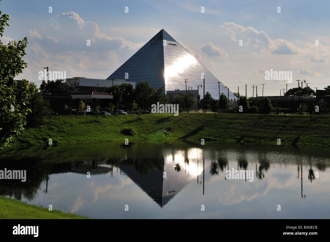 Reflection of the Pyramid Arena in a pond on a sunny summer evening in ...