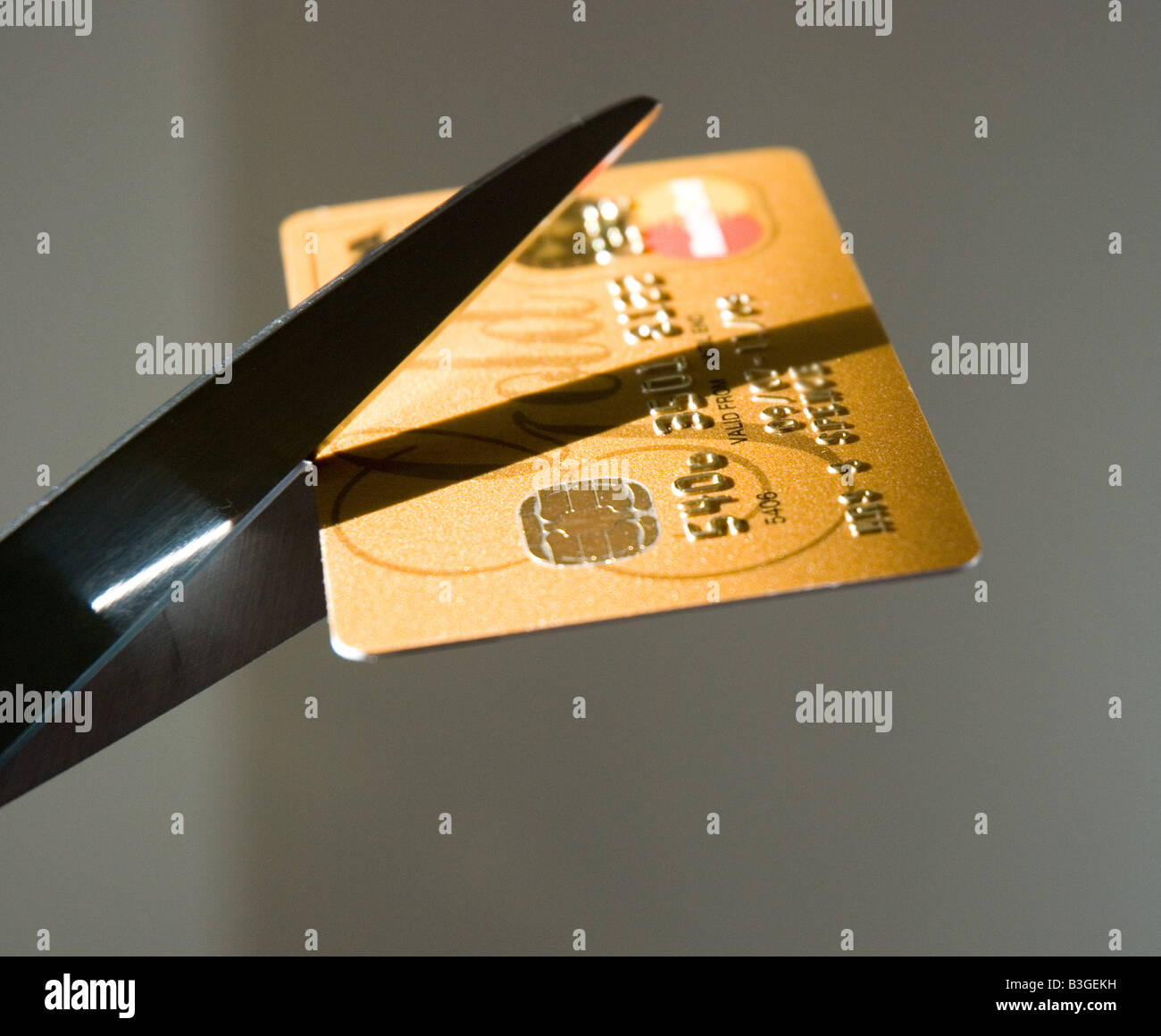 Credit card being cut by scissors Stock Photo - Alamy