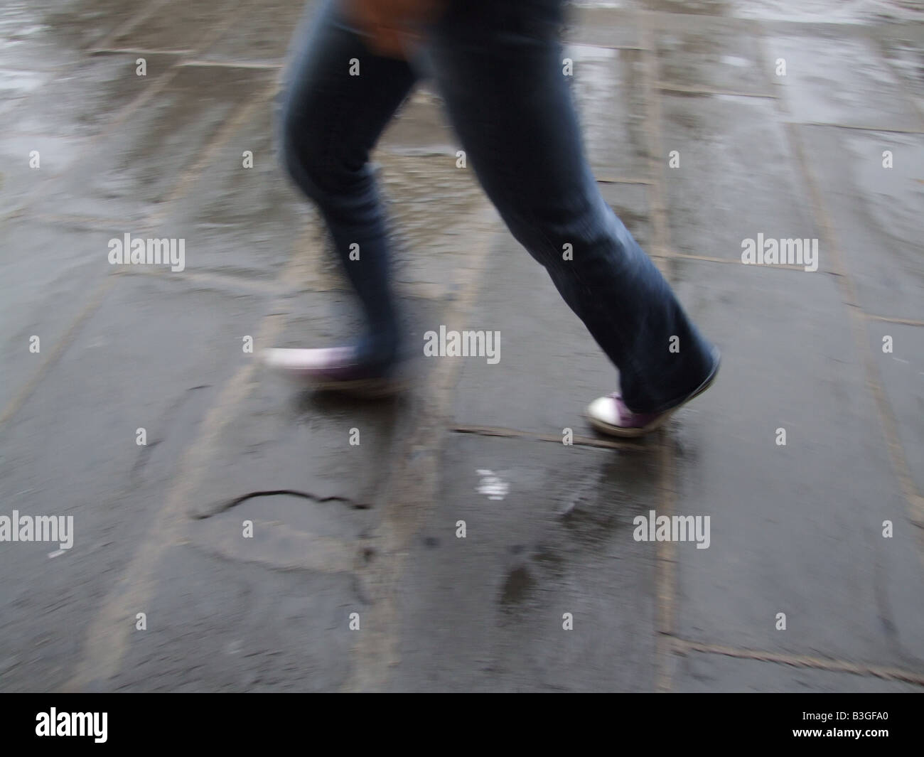 person walking in heavy rain in city town Stock Photo - Alamy