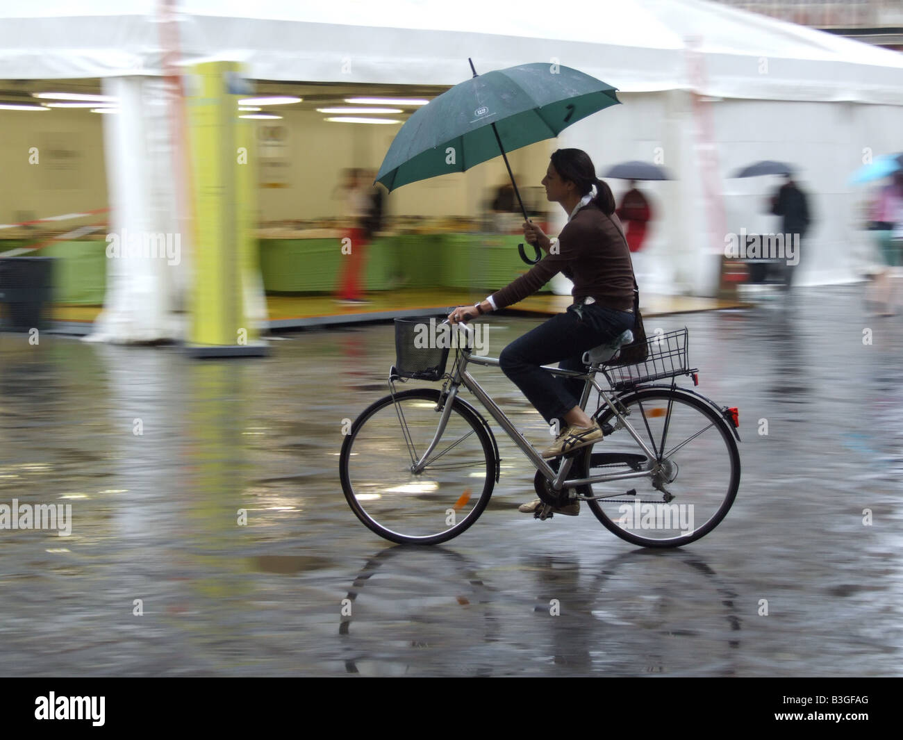 person with bike in rain in florence italy Stock Photo - Alamy