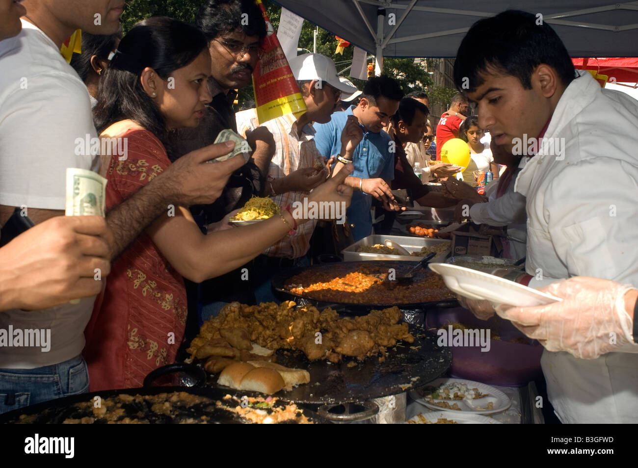 Paradegoers are served authentic Indian food from vendors at the street ...