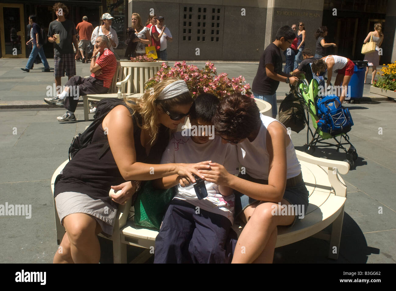 Tourists look at the screen of their digital camera at Rockefeller ...