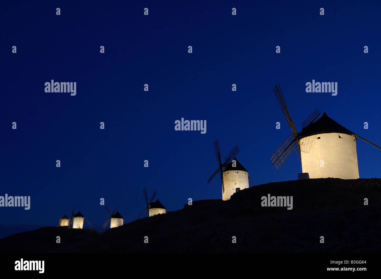 Row of illuminated windmills at dusk Stock Photo - Alamy