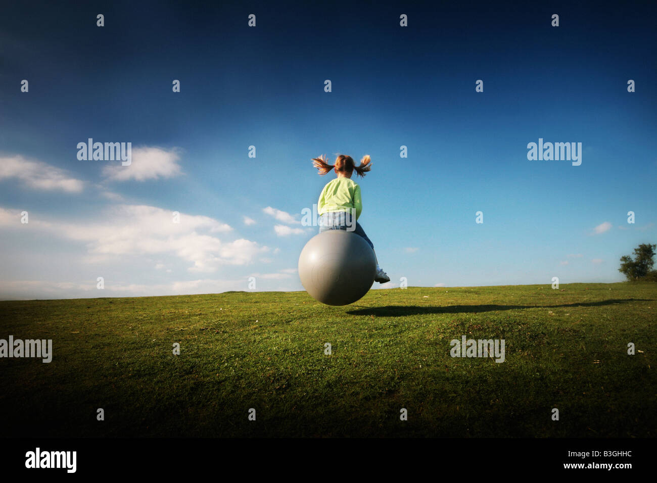 girl bouncing on a space hopper Stock Photo - Alamy