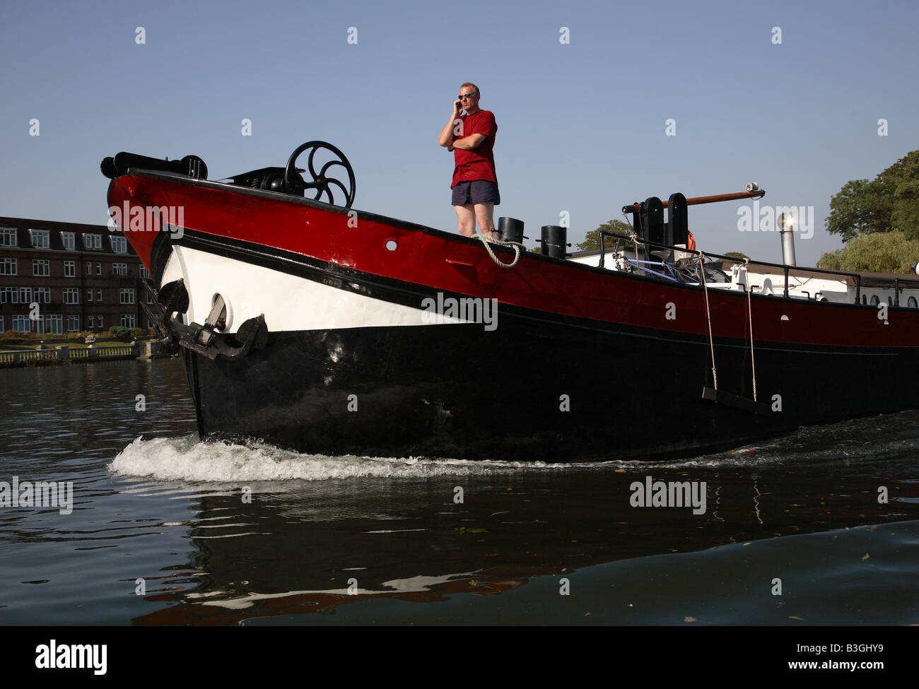 man on mobile on barge Stock Photo - Alamy