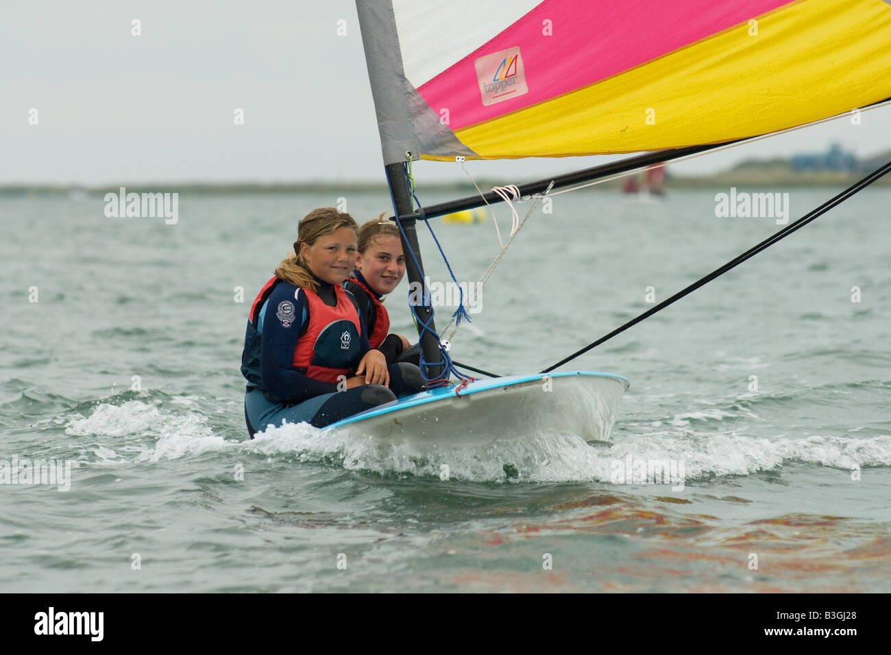 Two young girls racing their Topper sailing dinghy , Blakeney Regatta ...