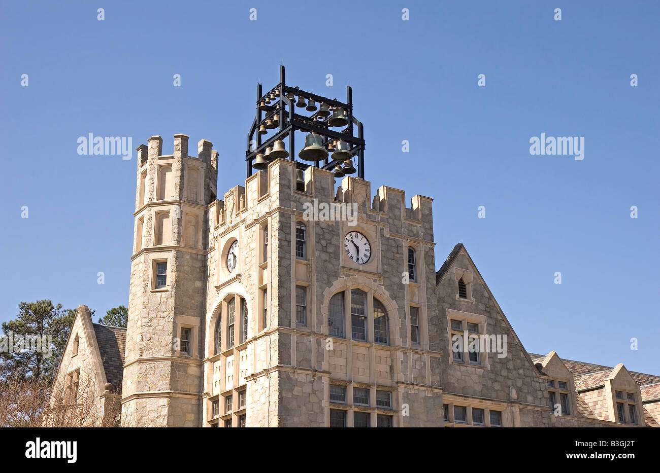 An old stone bell tower with a clock embedded in the face Stock Photo ...