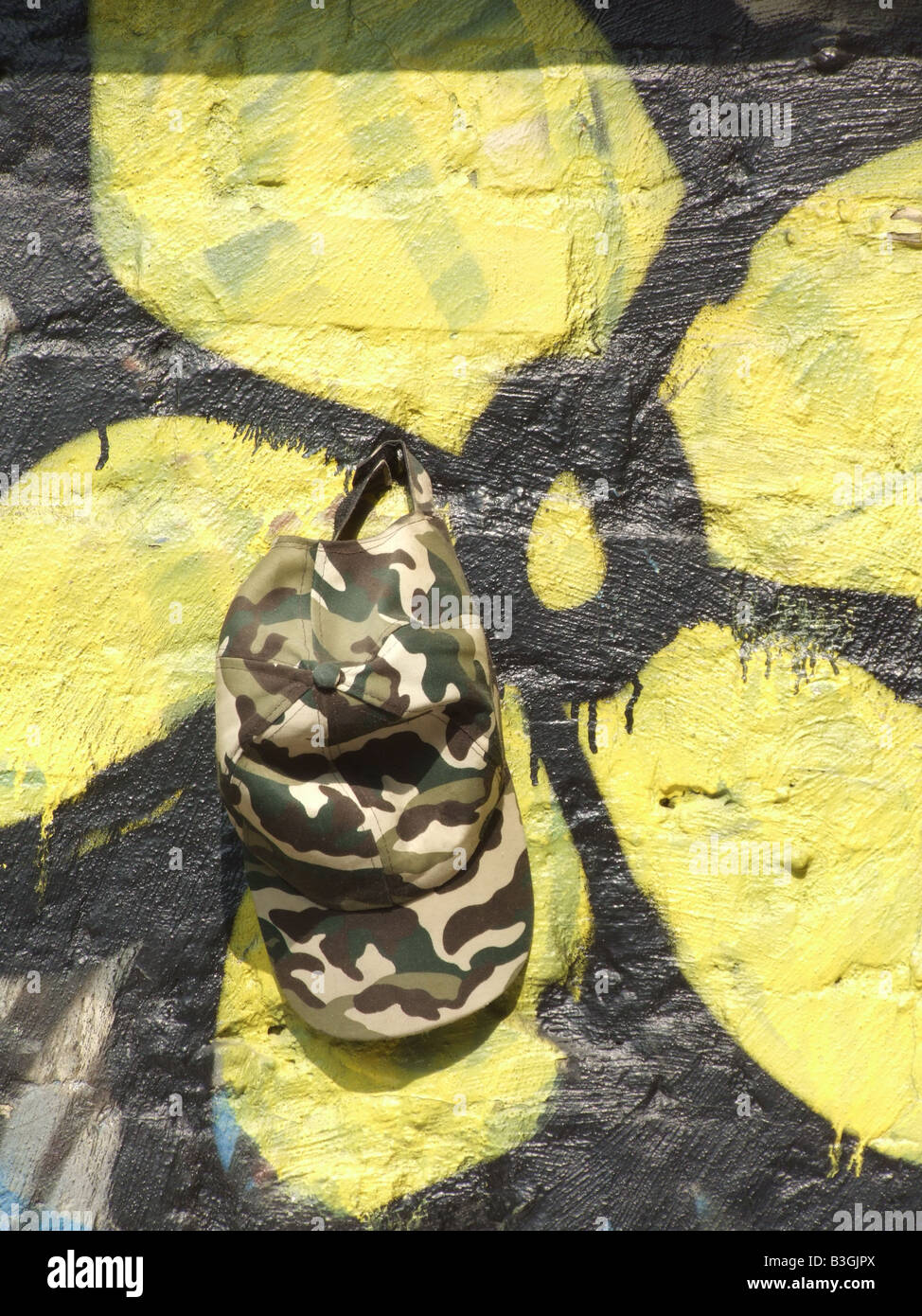 army cap and yellow flower graffiti on wall Stock Photo - Alamy