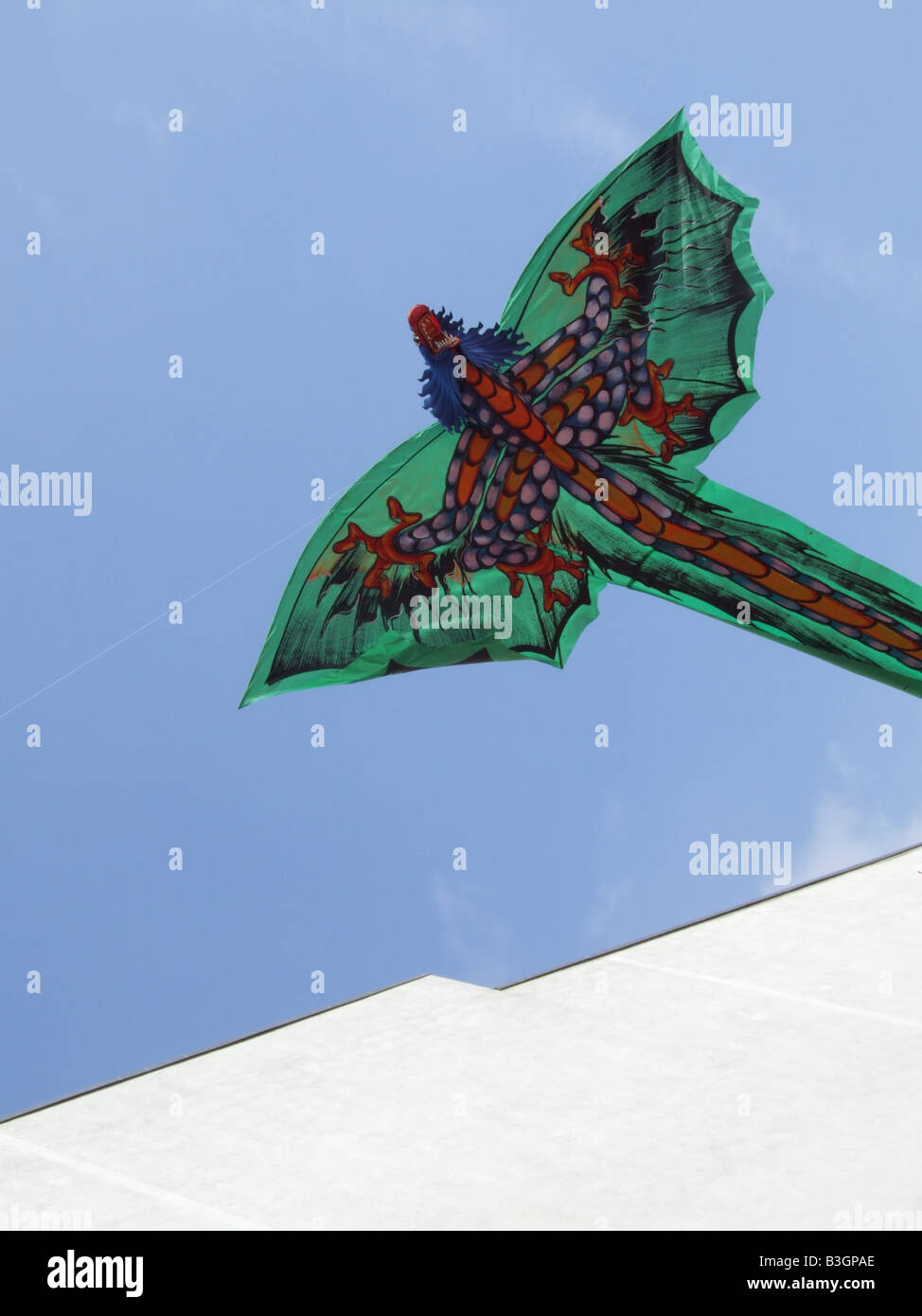 one oriental dragon kite flying in wind blue sky Stock Photo - Alamy