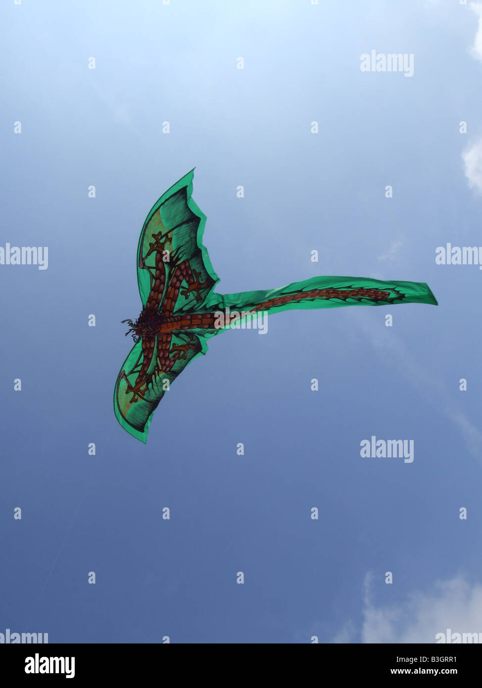 one oriental dragon kite flying in wind blue sky Stock Photo - Alamy