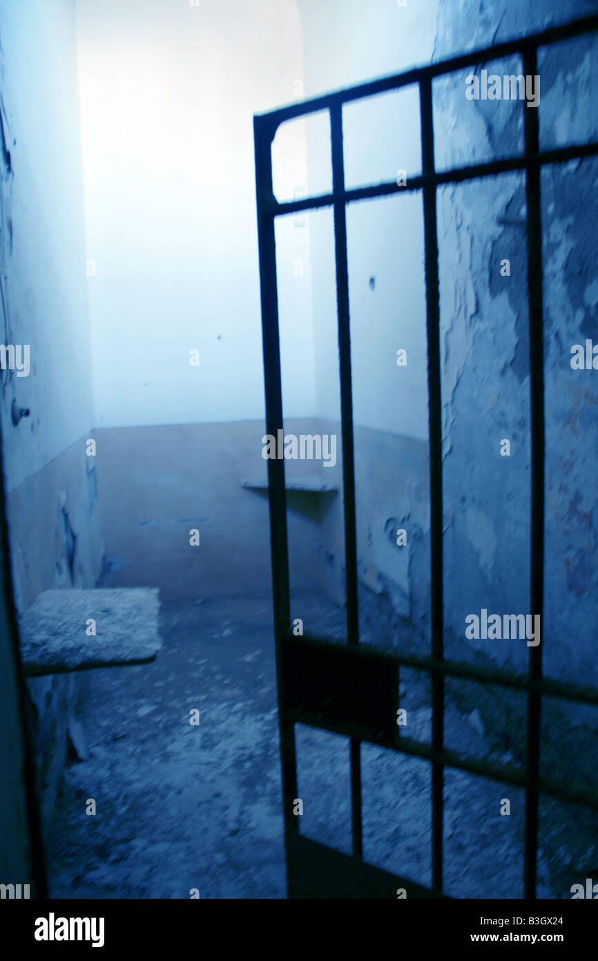 one old moody dark derelict empty prison cell Stock Photo - Alamy