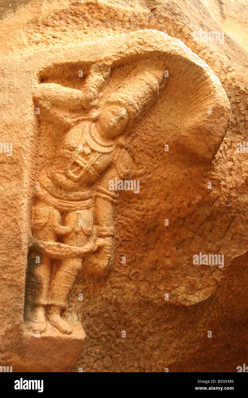 The figure of an ancient Hindu deity in one of the rock temples close ...