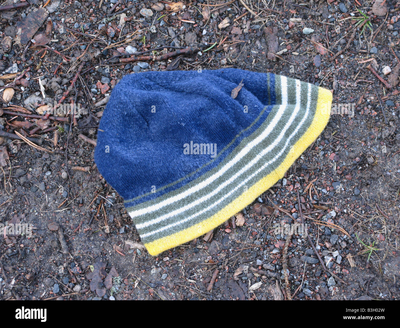 Childs knitted cap on the ground Stock Photo - Alamy