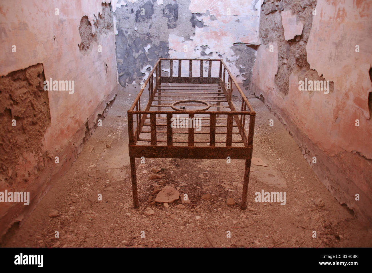 one old bed moody dark derelict empty prison cell Stock Photo - Alamy