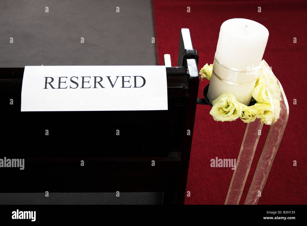 Reserved sign on chapel bench Stock Photo - Alamy