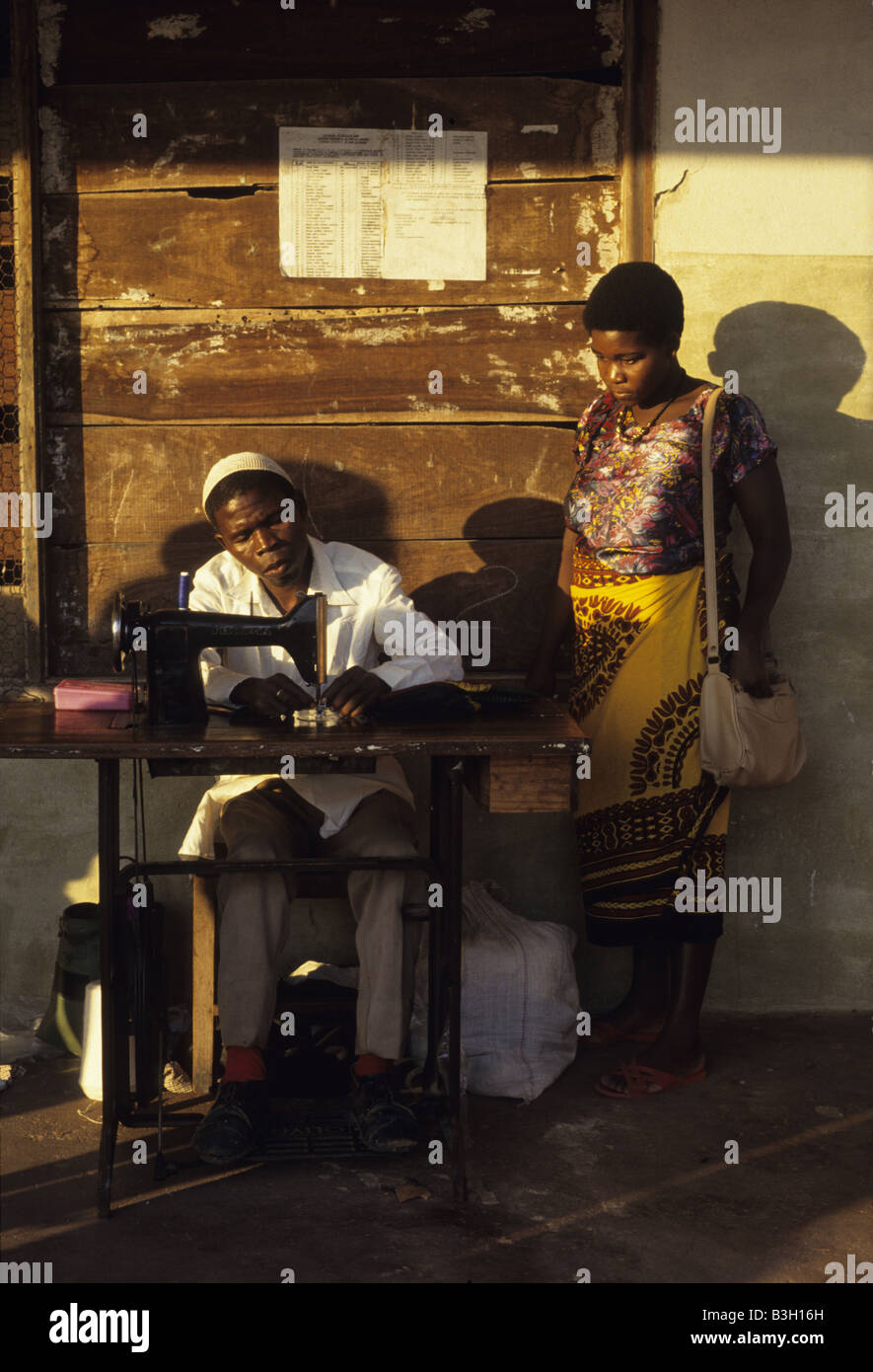 Mozambique 2001 Muslim tailor mending a garment for a customer Stock ...