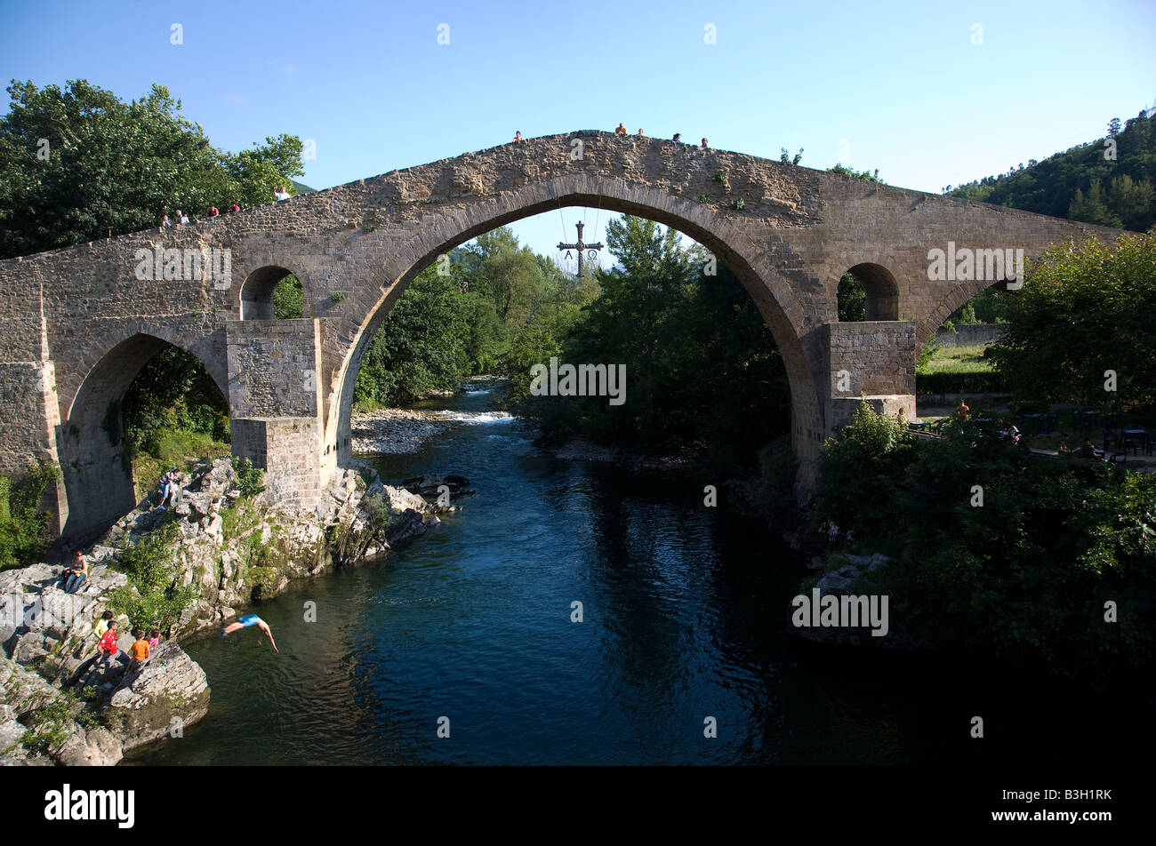 The medieval Puente Romano bridge in the town of Cangas de Onis in the ...