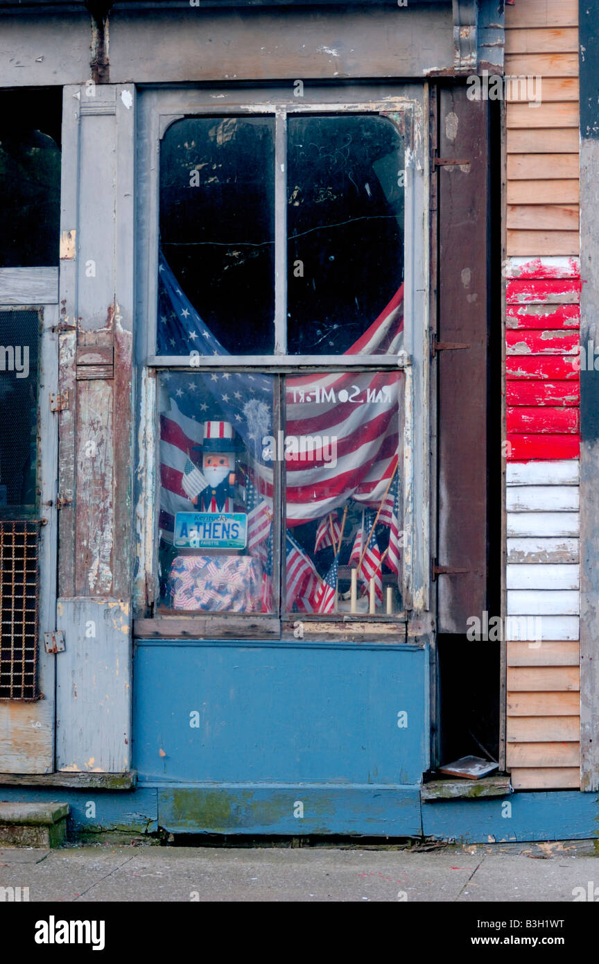 Old store front window with American flags displayed Stock Photo - Alamy