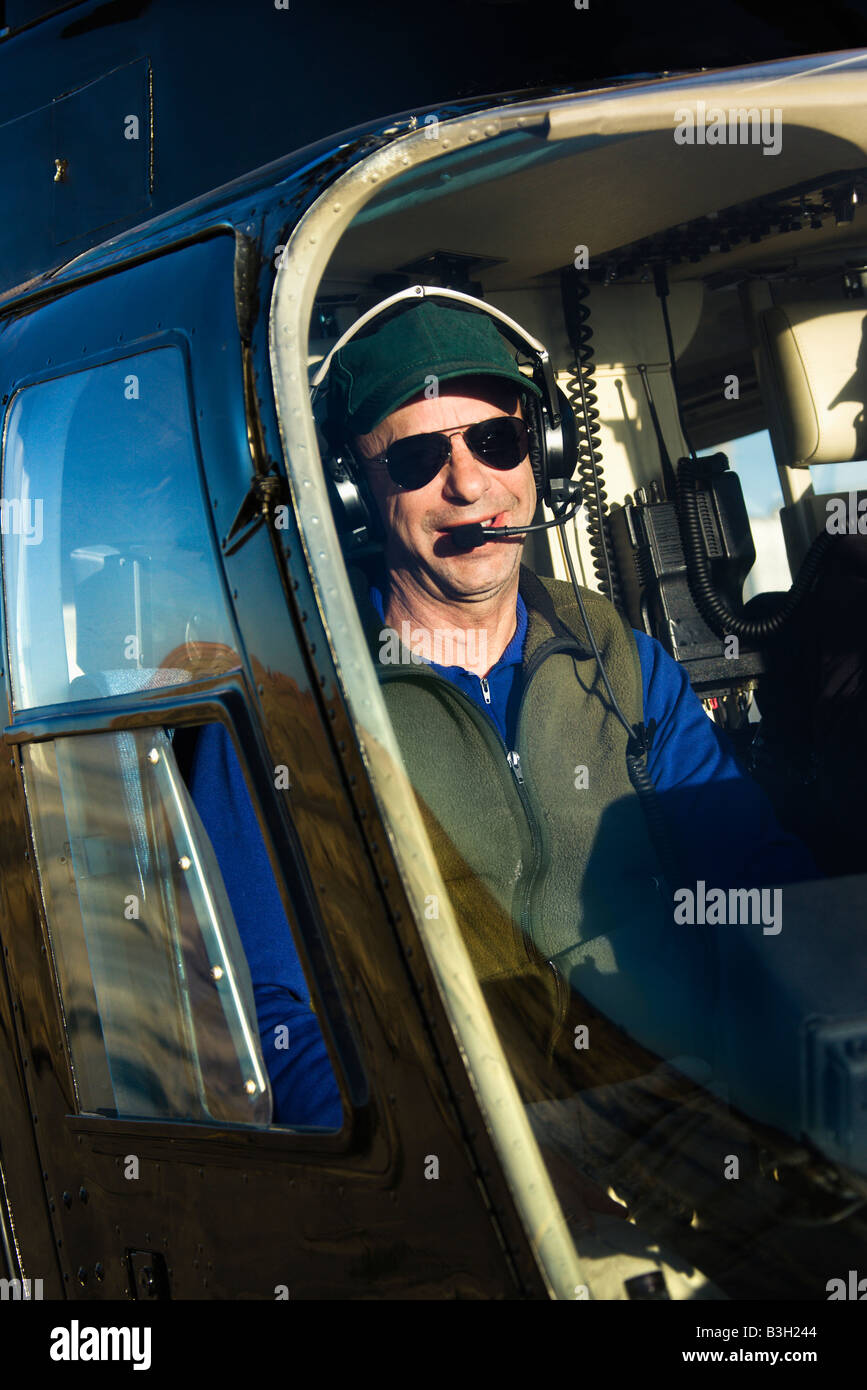 Portrait of helicopter pilot sitting in cockpit looking at viewer Stock ...