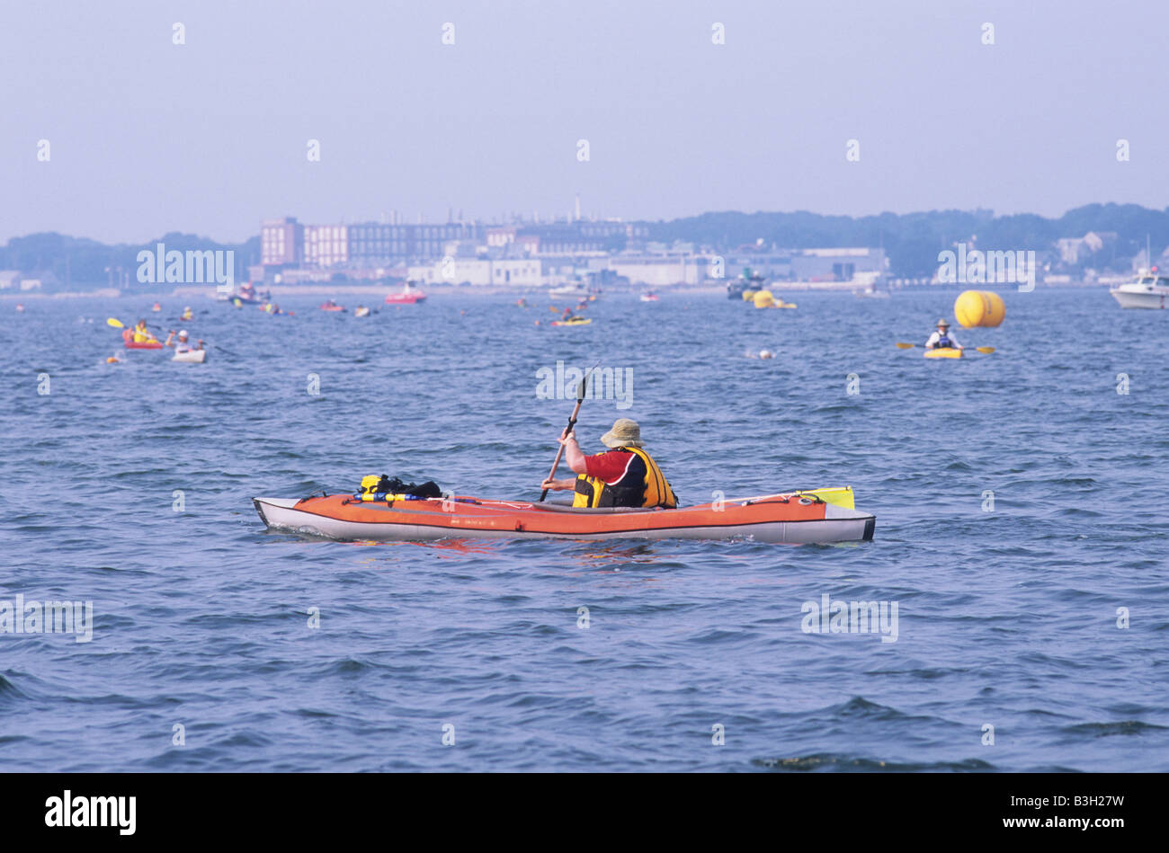 1 One kayak in ocean with New Bedford, MA in background. 1 one person ...