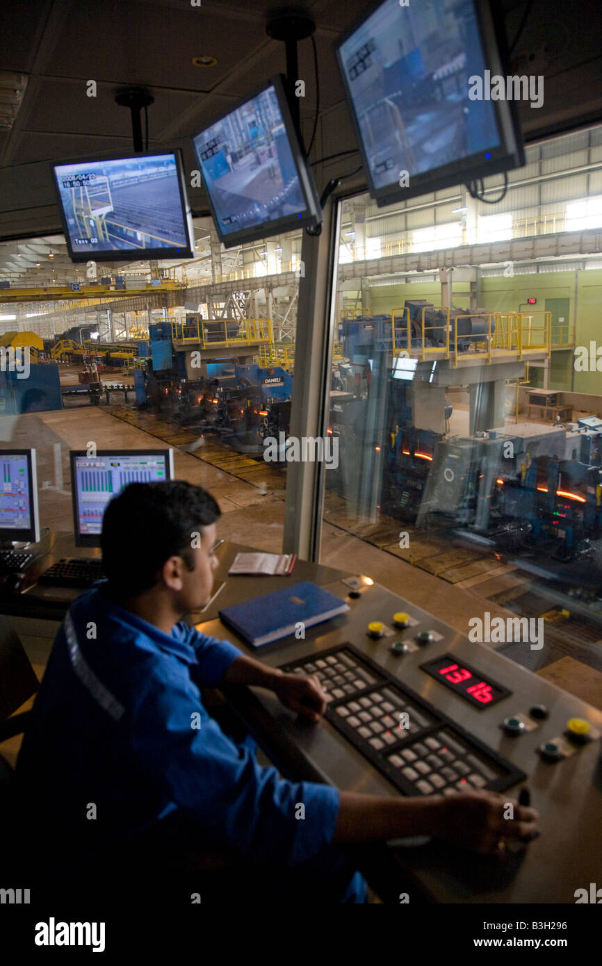 Worker in control booth checking production line at EISF Steel Plant ...