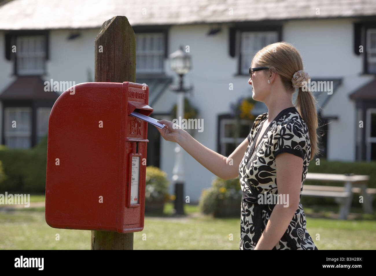 Woman posting letters letterbox hi-res stock photography and images - Alamy