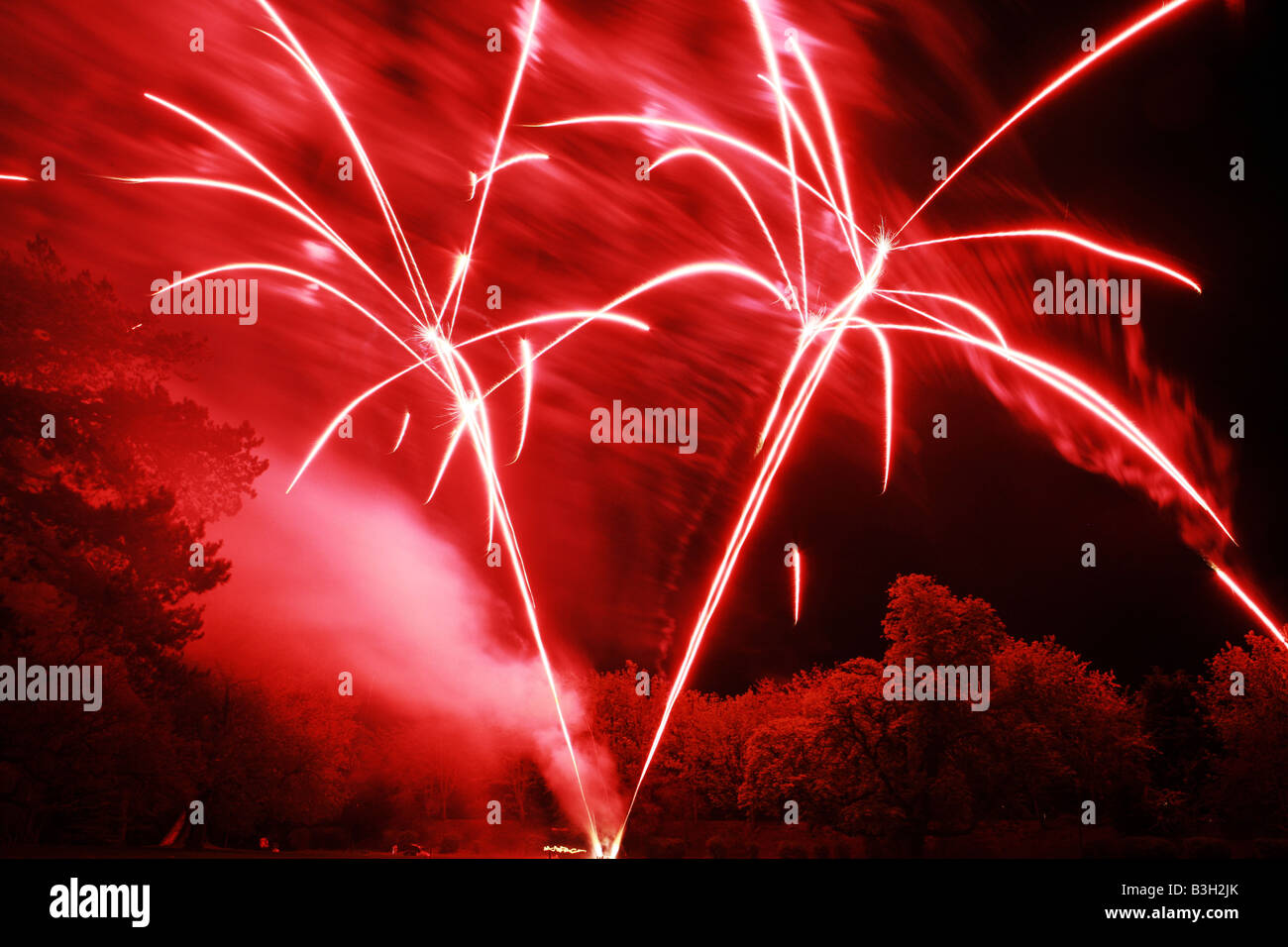 Two large red fireworks exploding in the sky Stock Photo - Alamy