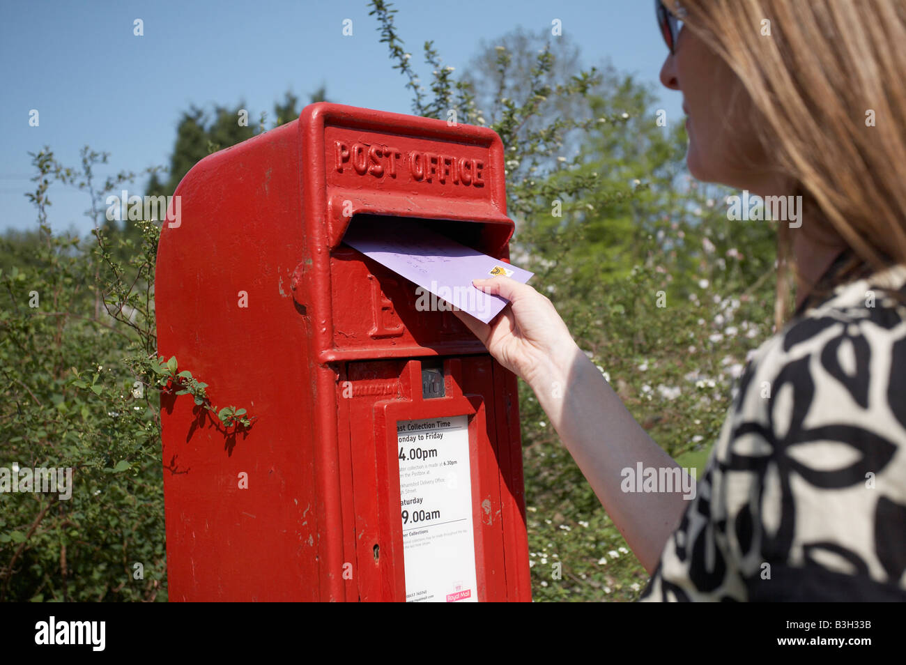 Woman posting a letter Stock Photo - Alamy