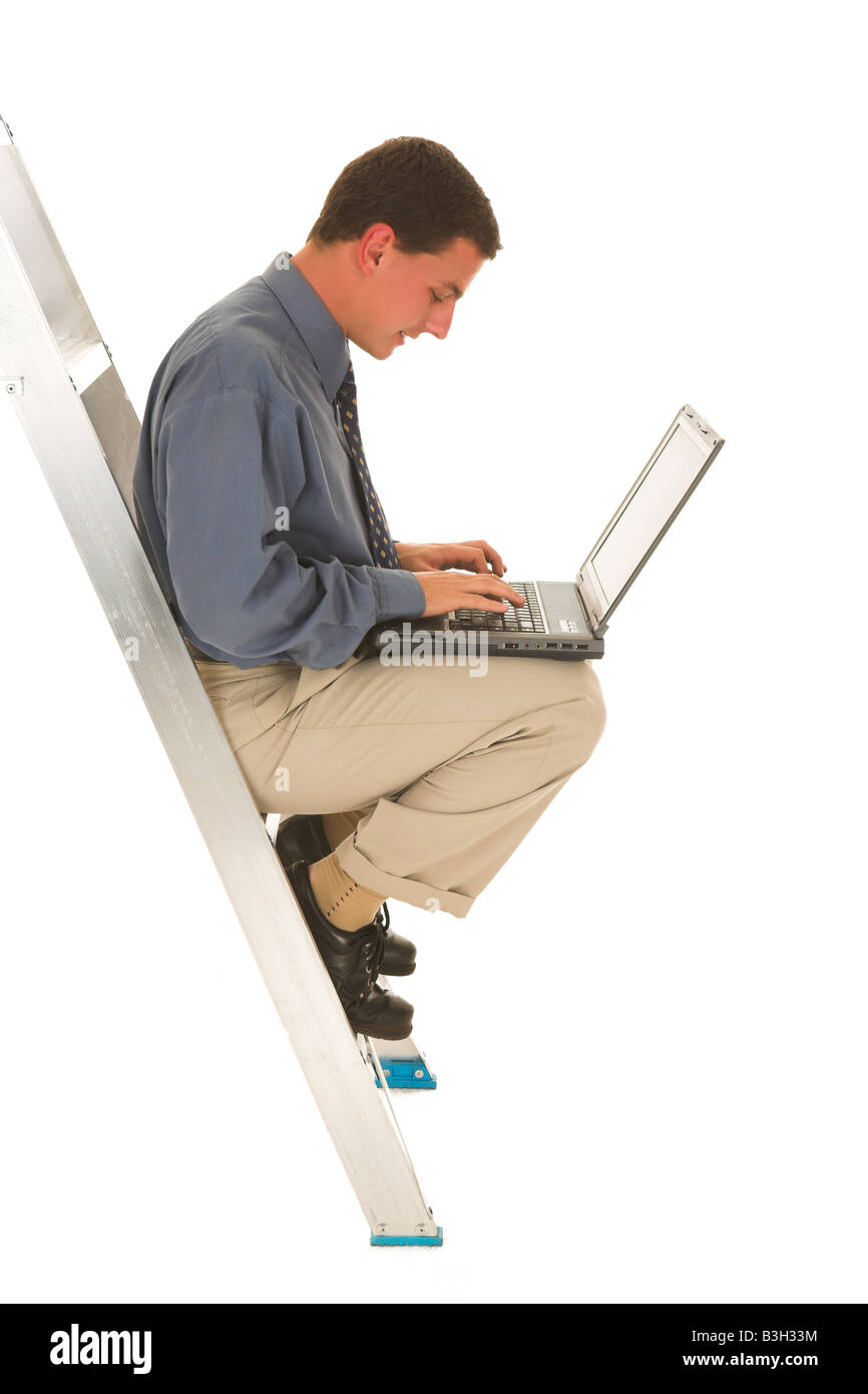 Man sitting on ladder working on laptop Stock Photo - Alamy