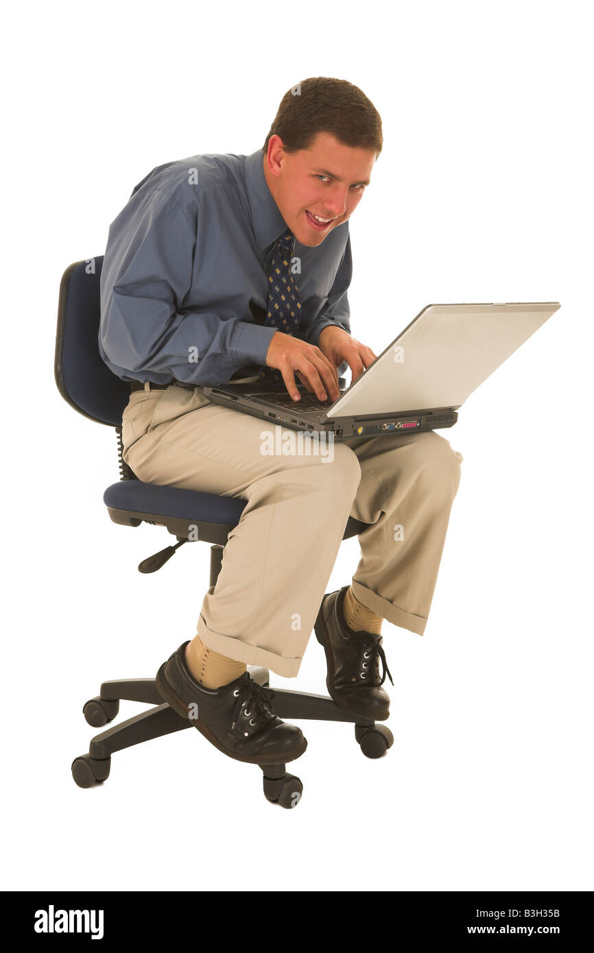 Man working on laptop sitting on a office chair Stock Photo - Alamy