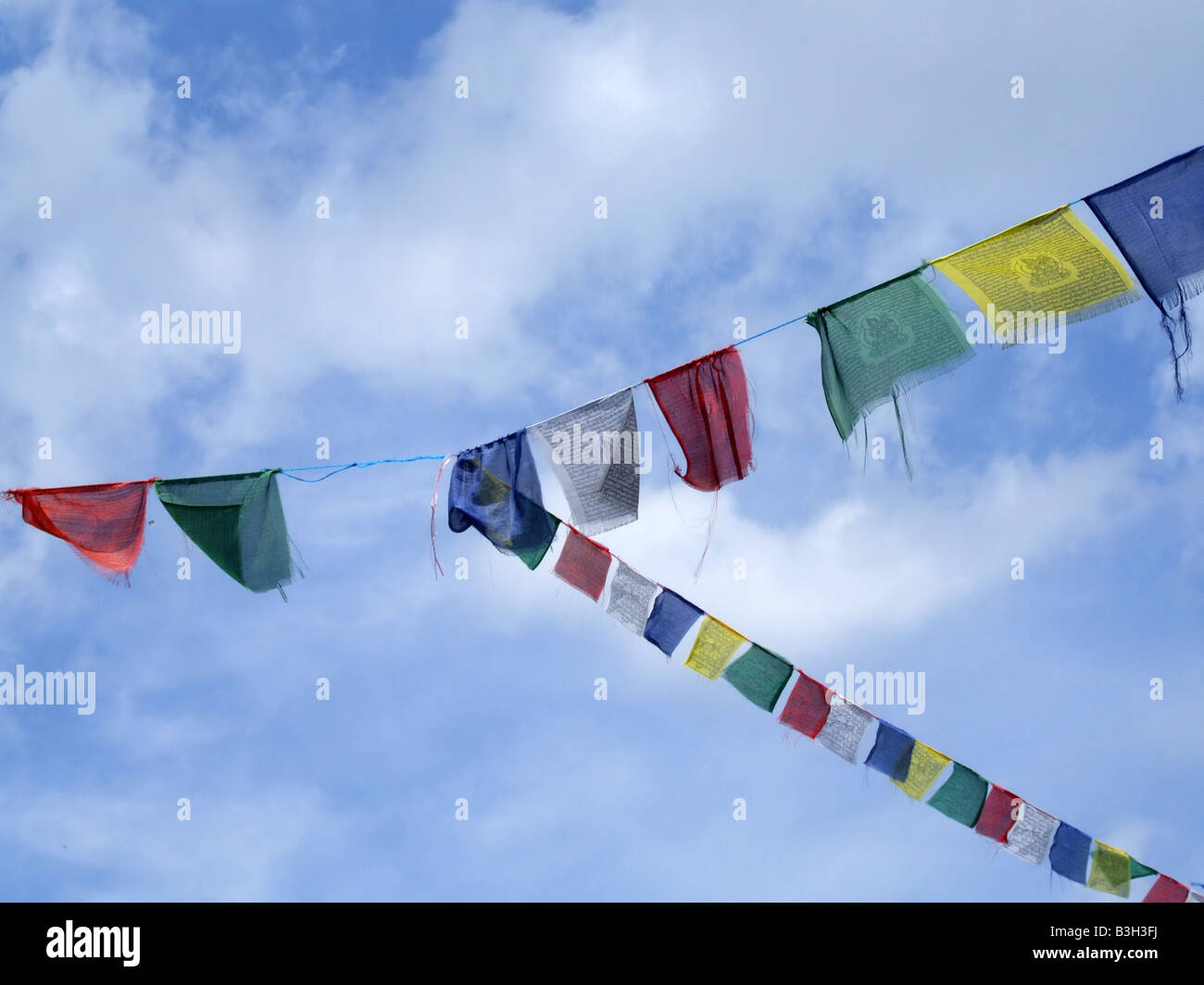 colourful buddhist prayer flags and blue sky Stock Photo - Alamy