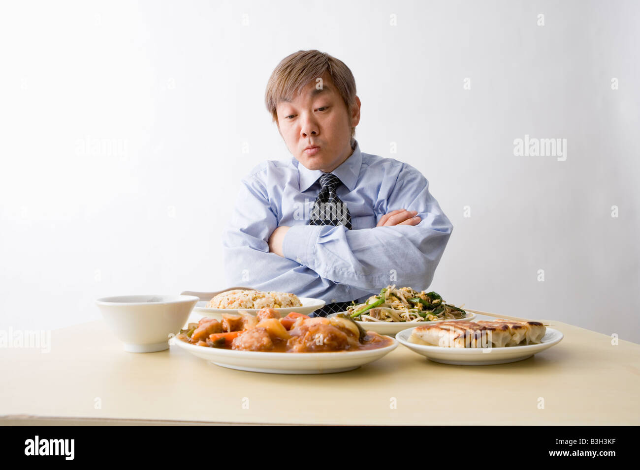 Businessman sitting in front of food Stock Photo - Alamy