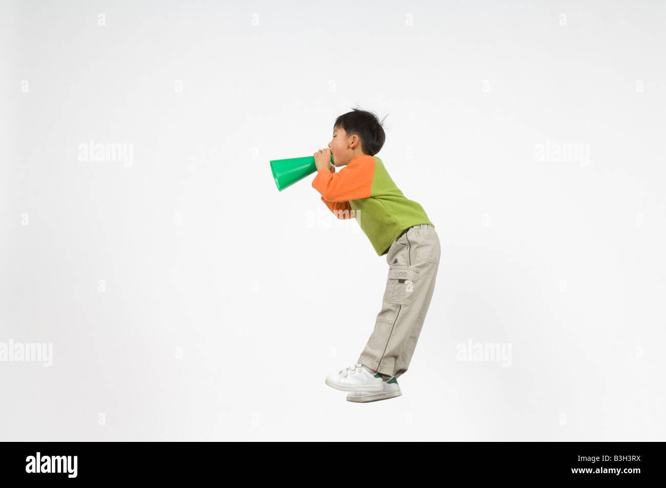 Boy cheering with megaphone Stock Photo - Alamy