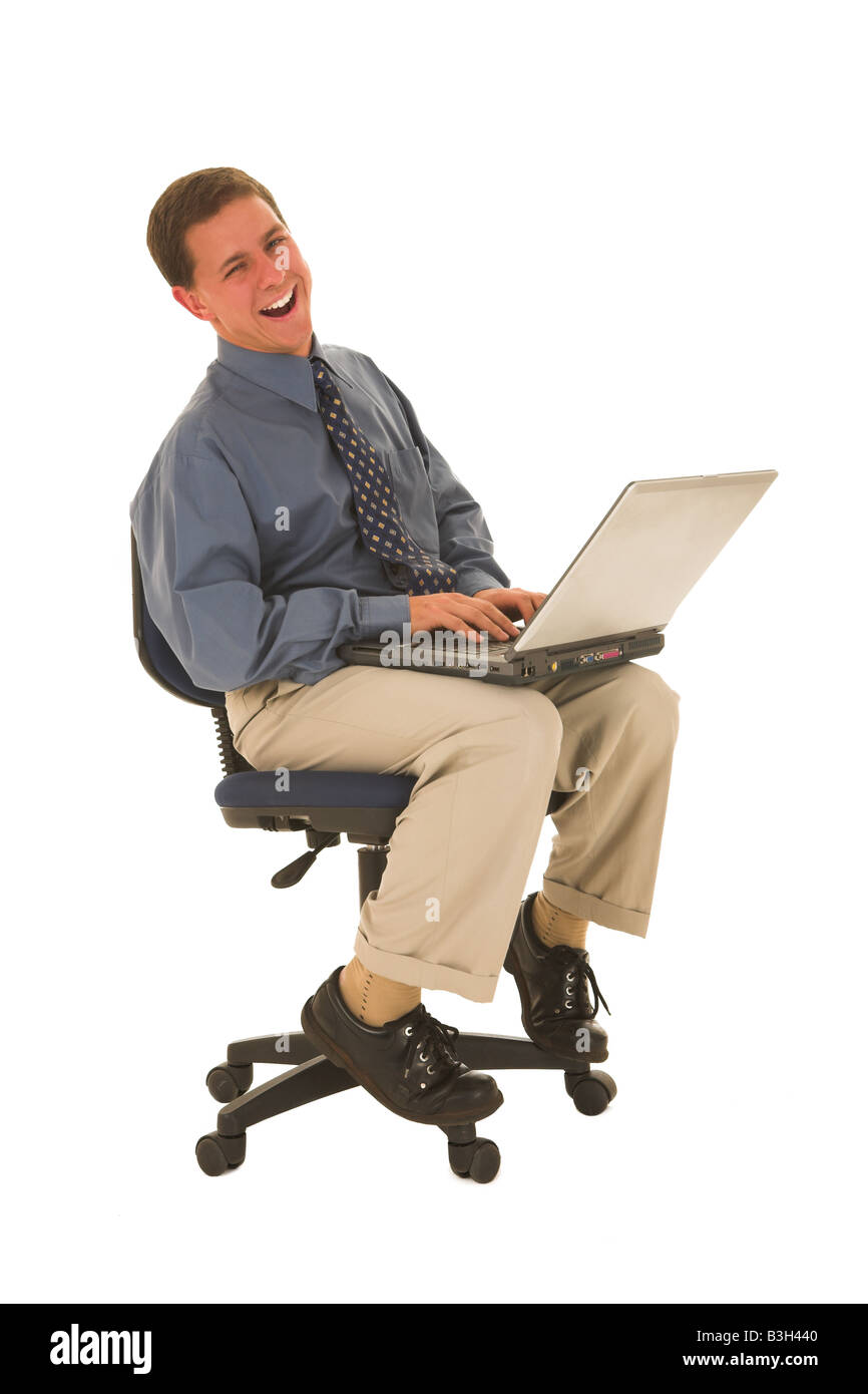 Man sitting on chair working on a laptop Stock Photo - Alamy
