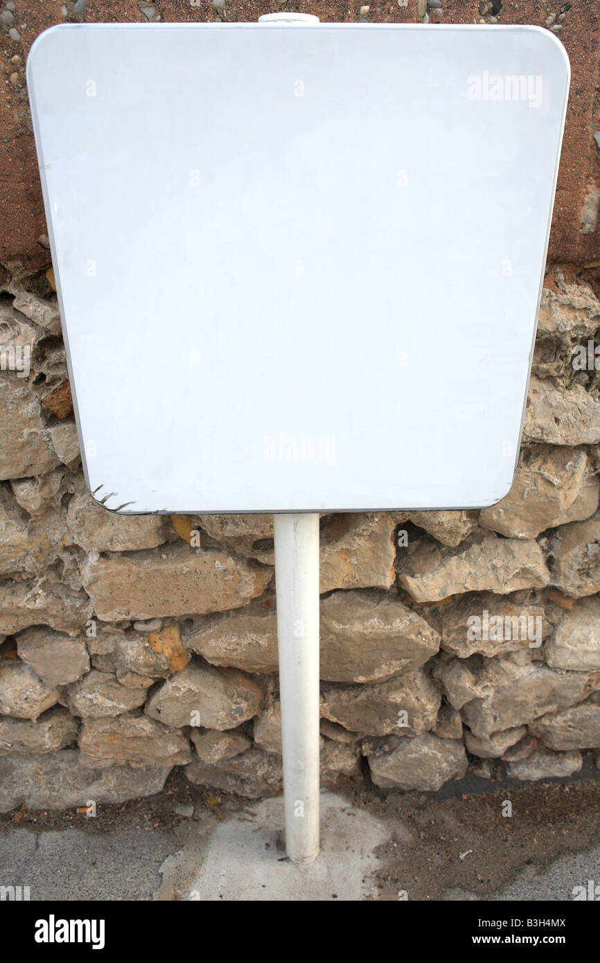 White sign in front of a wall Stock Photo - Alamy