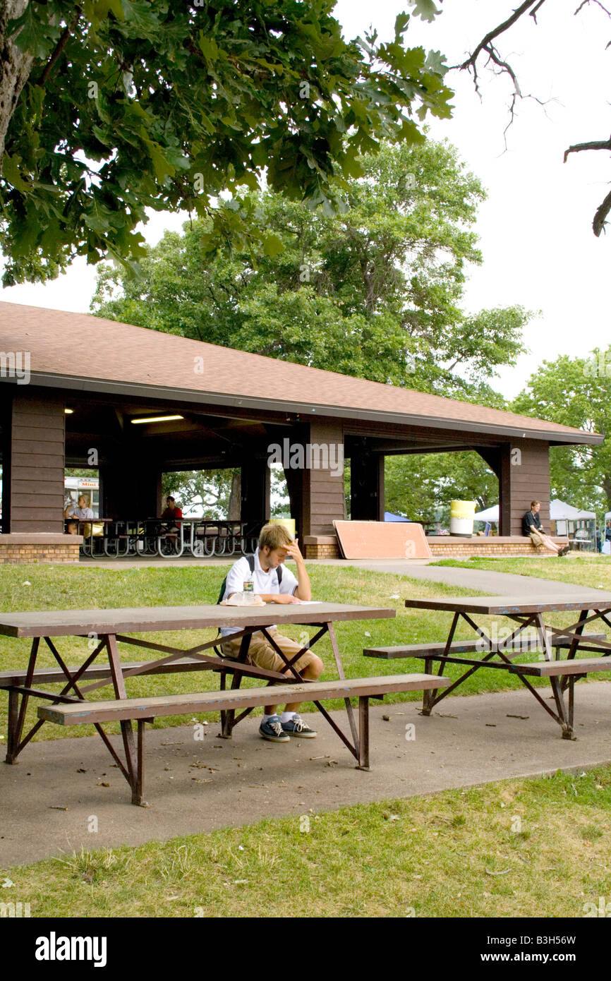 Man age 22 taking an early morning break. Dragon Festival Lake Phalen ...