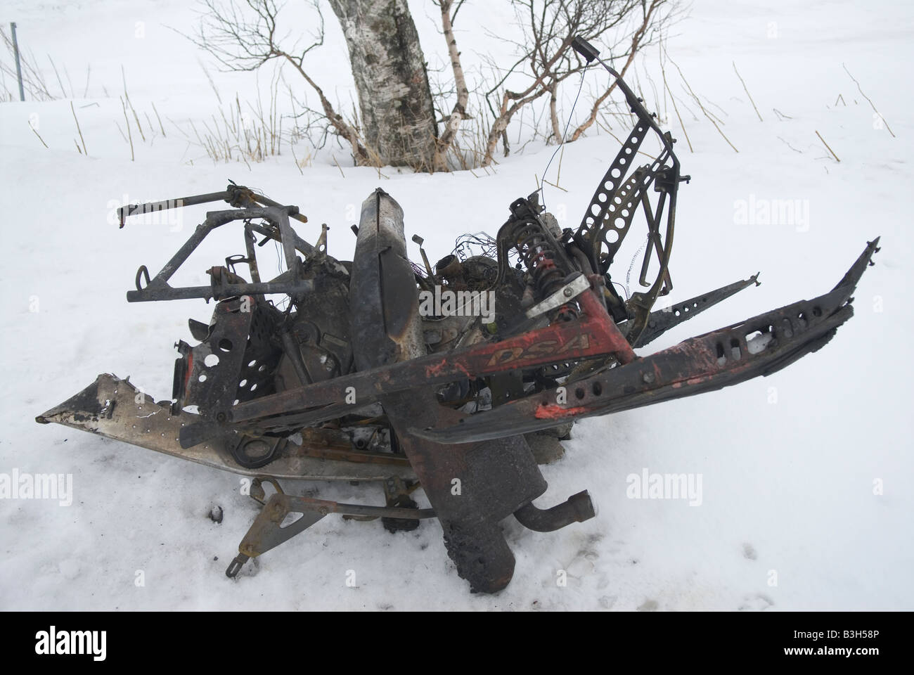 Smashed and burned snowmobile wreck Stock Photo - Alamy
