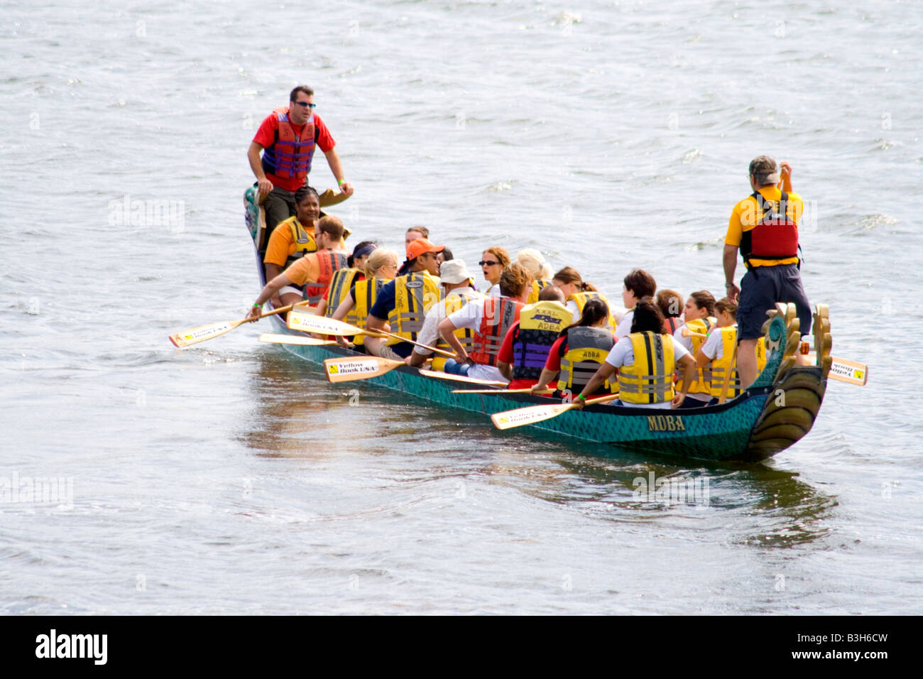 Asian dragon racing boat being steered into dock area. Dragon Festival ...