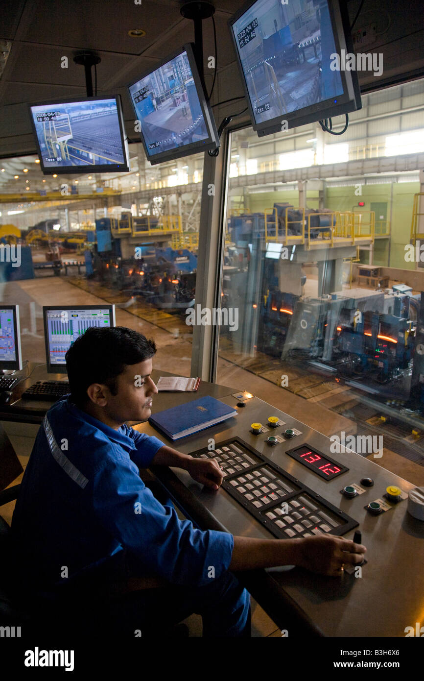 Worker in control booth checking production line at EISF Steel Plant ...