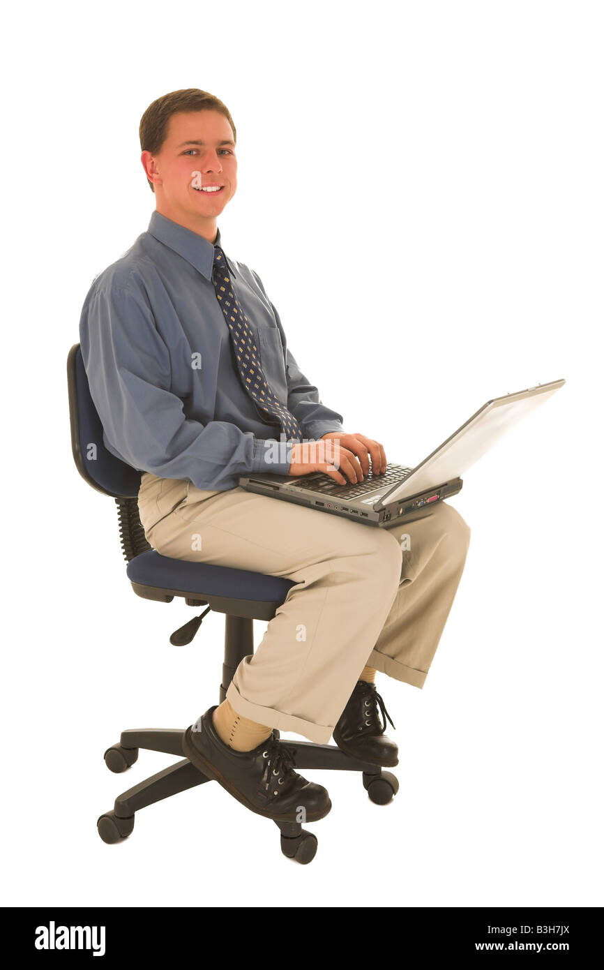 Man sitting on a chair working on laptop Stock Photo - Alamy