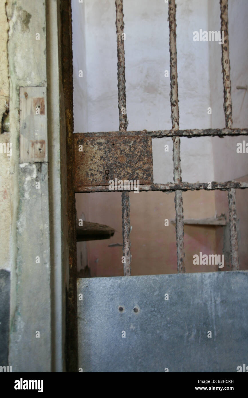 one old moody dark derelict empty prison cell Stock Photo - Alamy